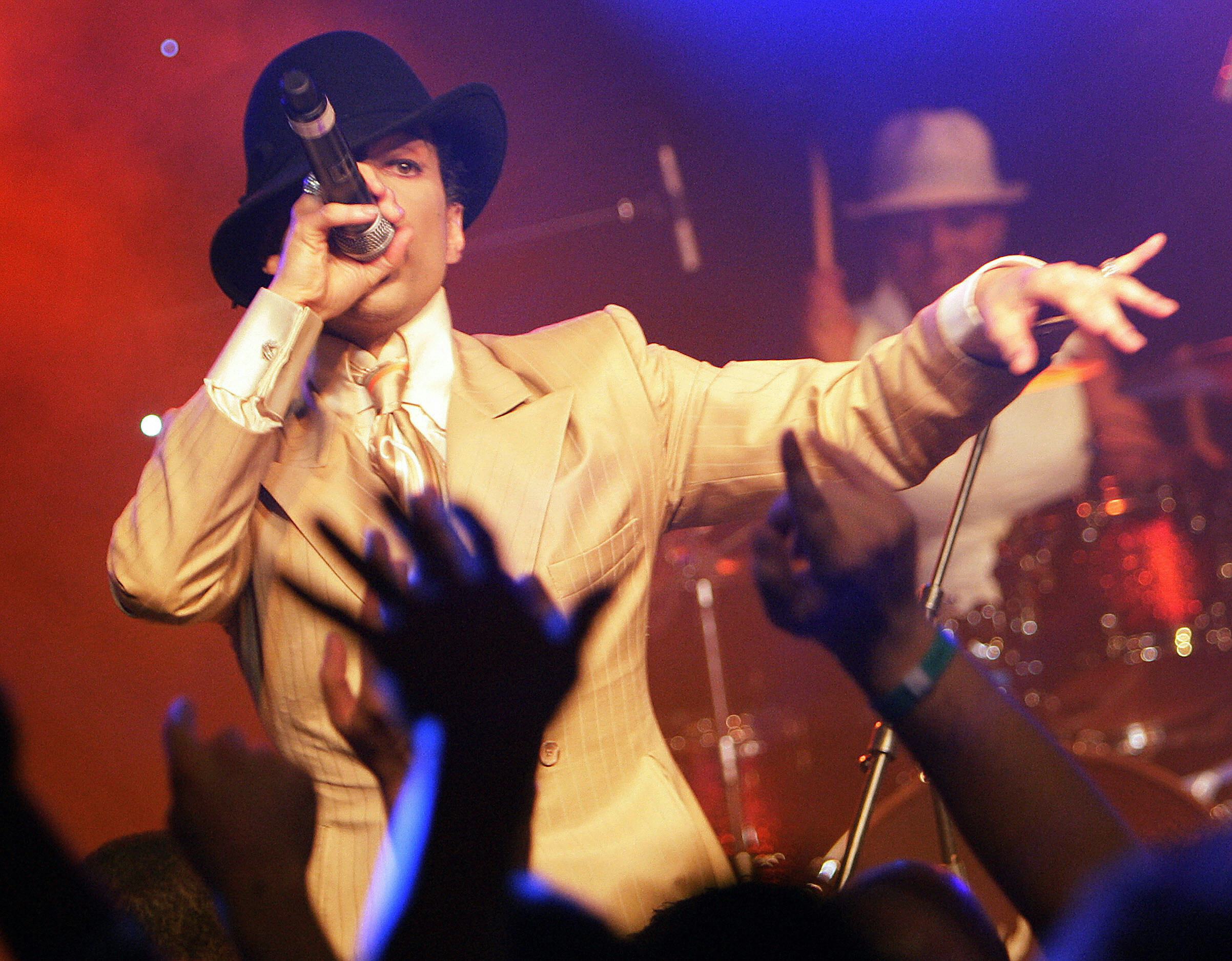 17 Of Prince's Most Iconic Outfits, Because He Could Rock A Feather Boa