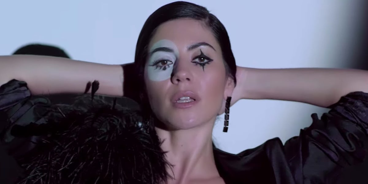 Marina Is A Sad Jester In Dramatic "Karma" Acoustic Video