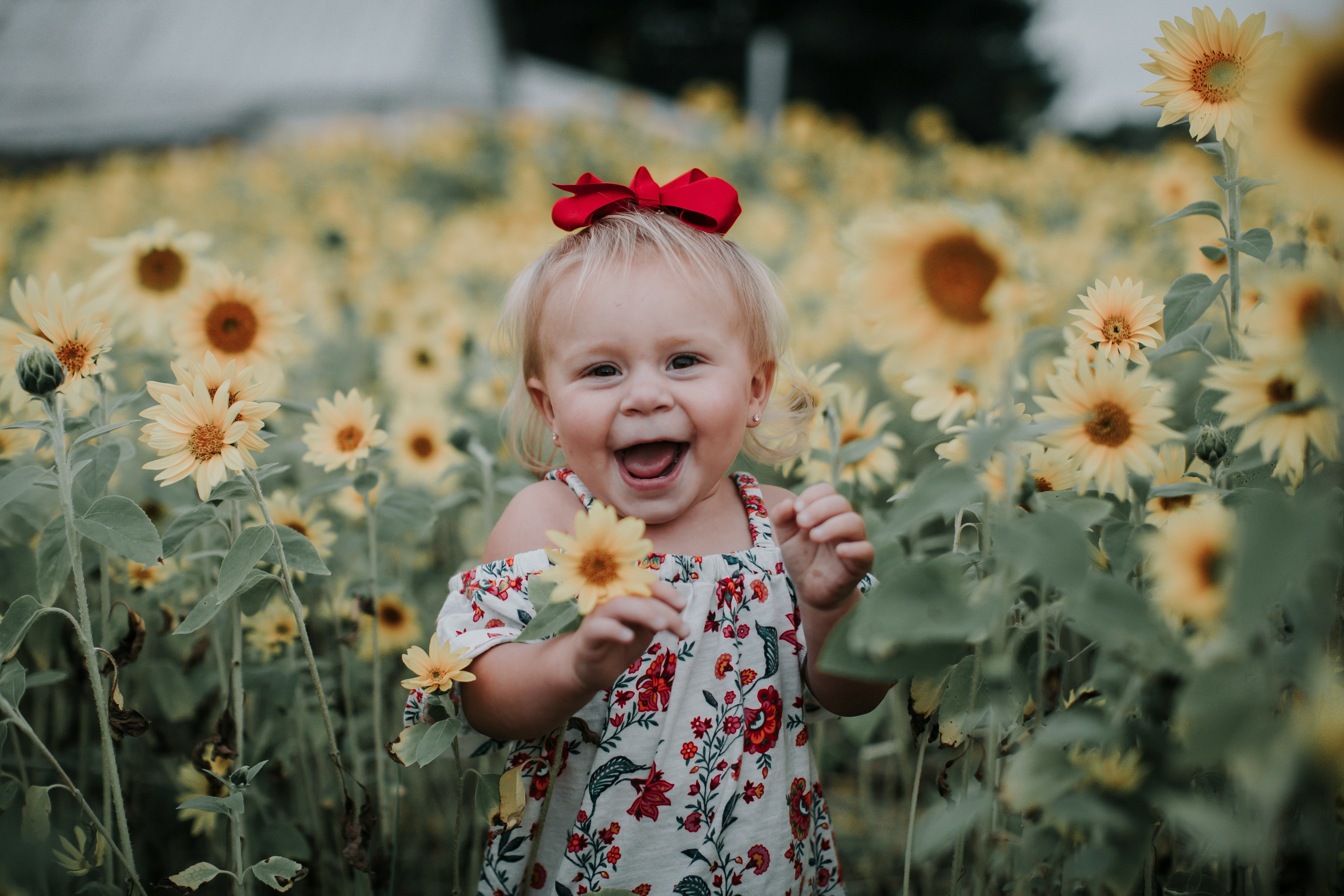 These 90 Baby Names That Mean Red Are Inspired By Fire, Flowers, & Folklore