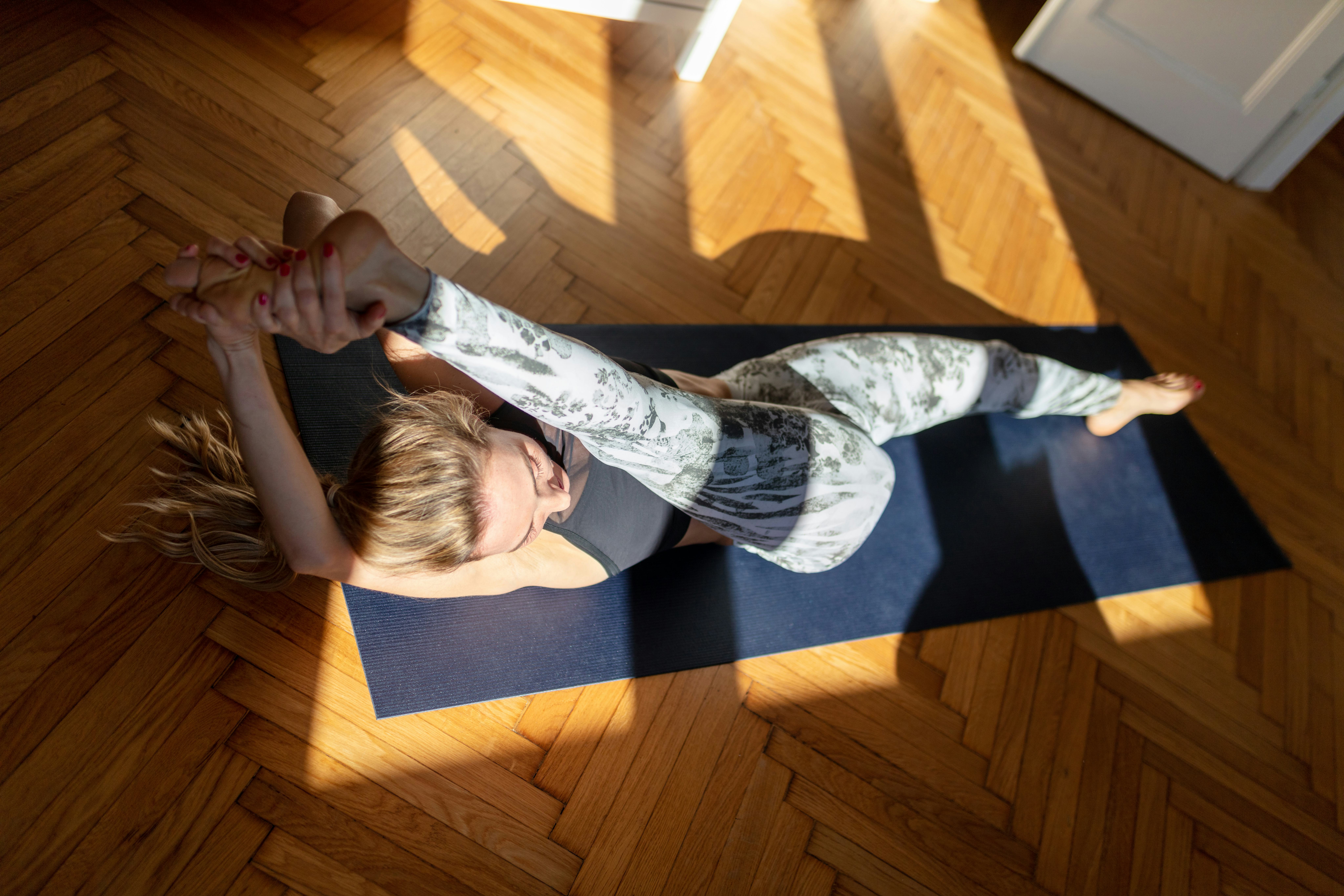 The 10 Best Stretches To Do Before Bed, According To Trainers