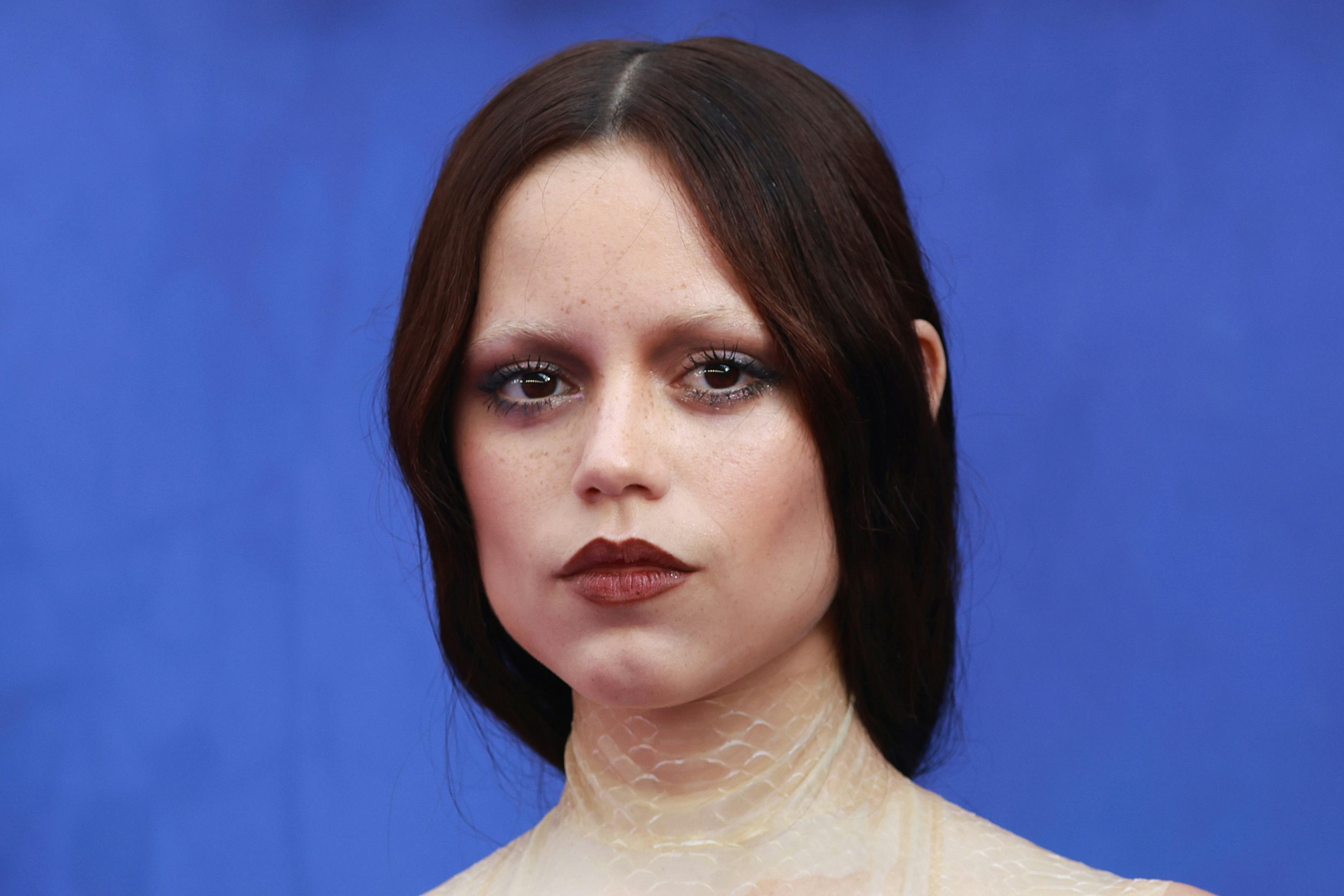 Jenna Ortega Paired A Realistic Sheer “Snakeskin” Dress With A Vampy Lip