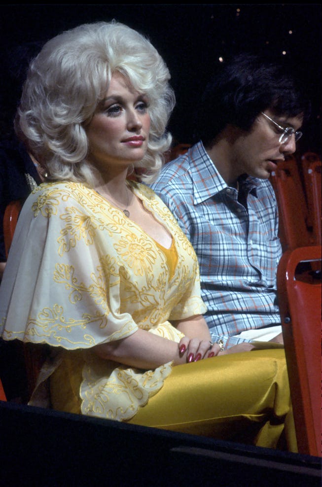 Dolly Parton’s Best Beauty Moments Include High Hair And Frosty Glam