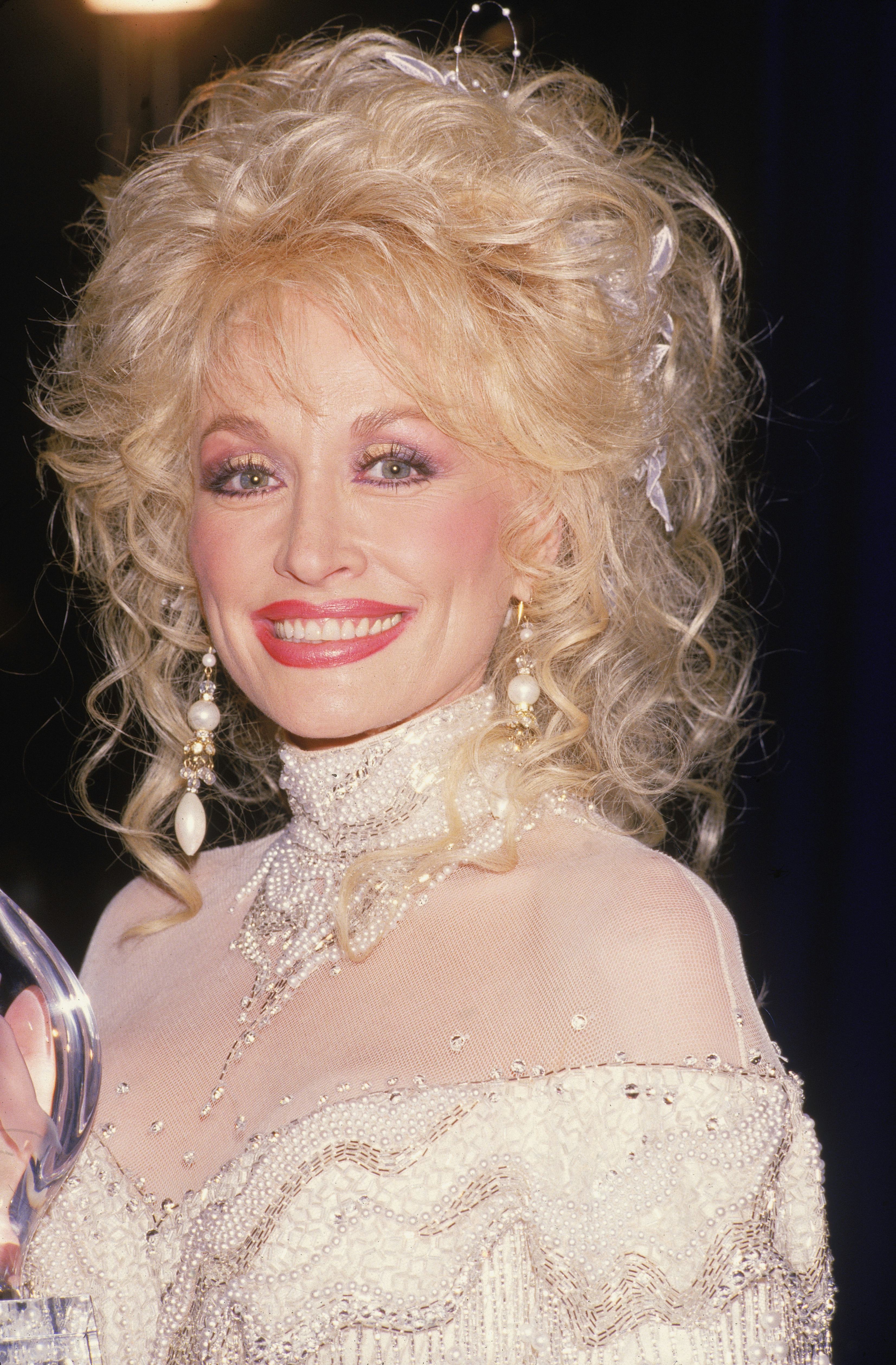 Dolly Parton’s Best Beauty Moments Include High Hair And Frosty Glam