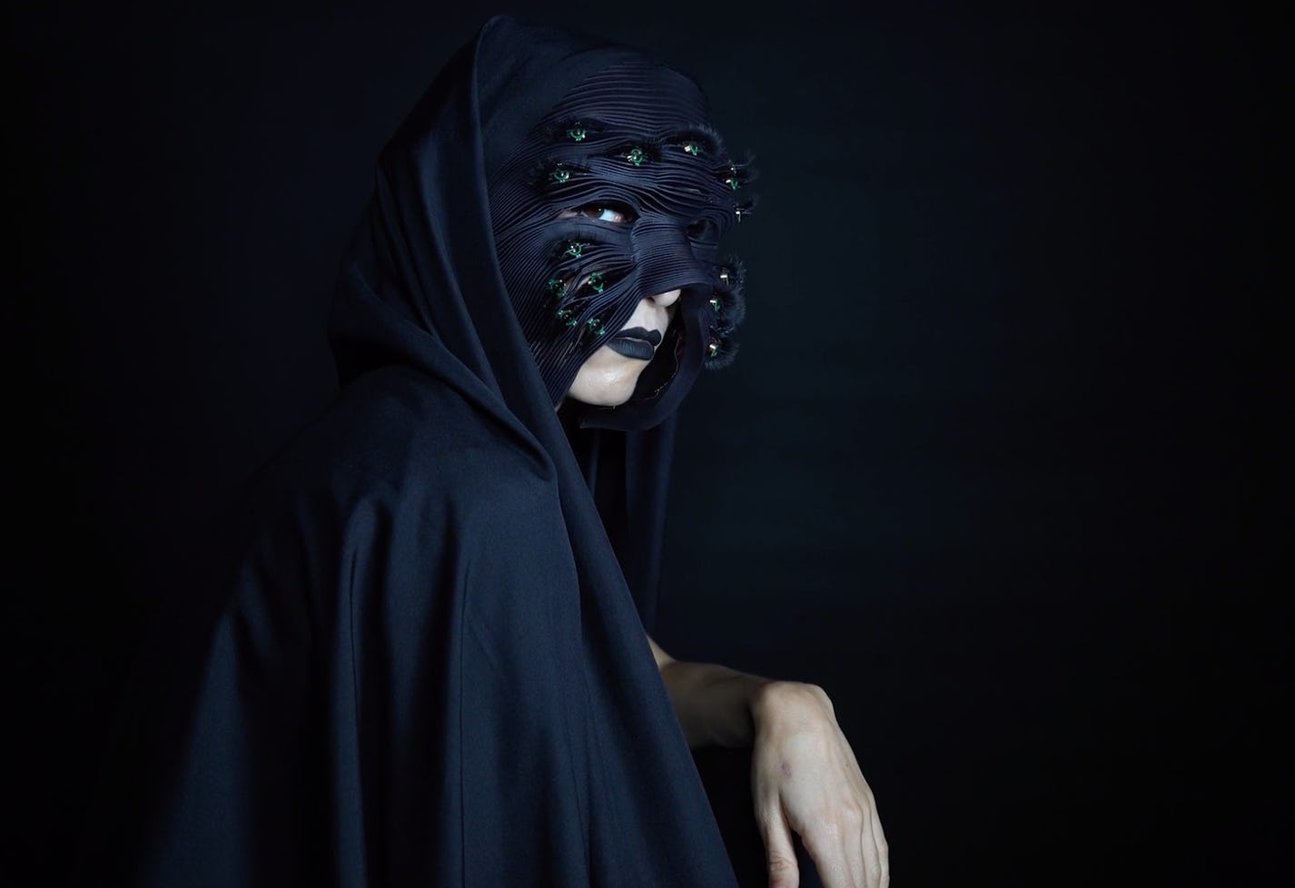 These blinking AI face masks send a feminist message in the eeriest way