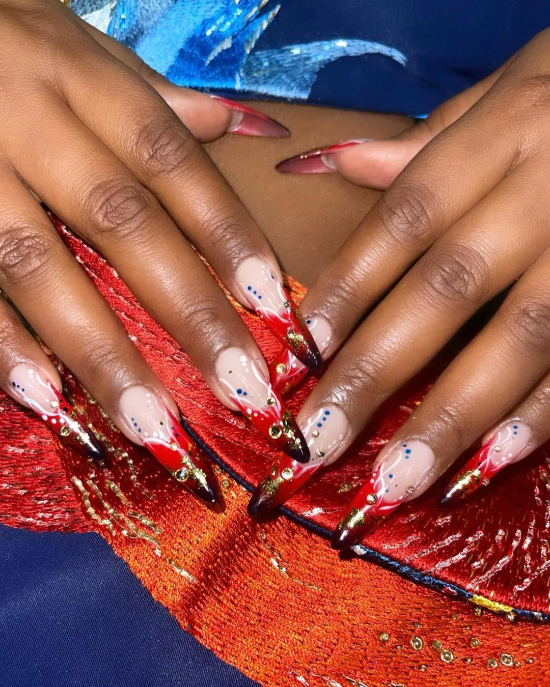 Lizzo's Red & Gold Nails Are A Whole New Way To Do French Manicures