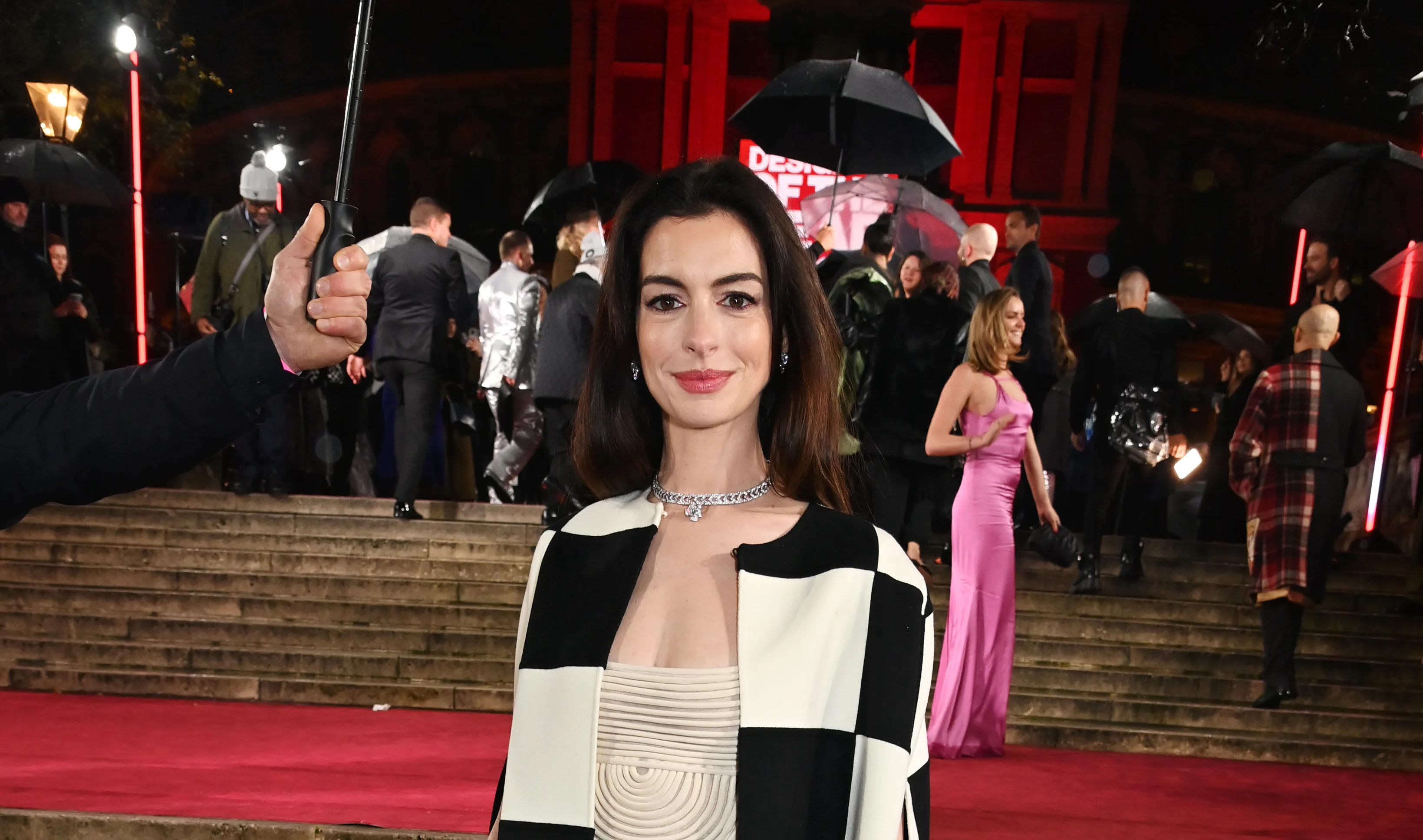 Anne Hathaway Serves '60s Socialite In a Checkerboard Coat