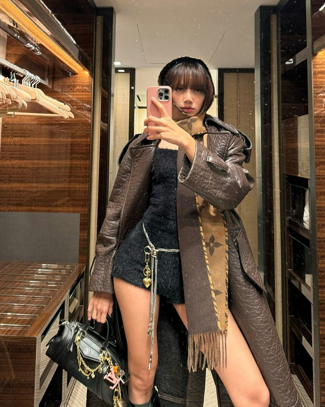 Blackpink's Lisa Pairs Shredded Knitwear With a Lingerie Garter Belt