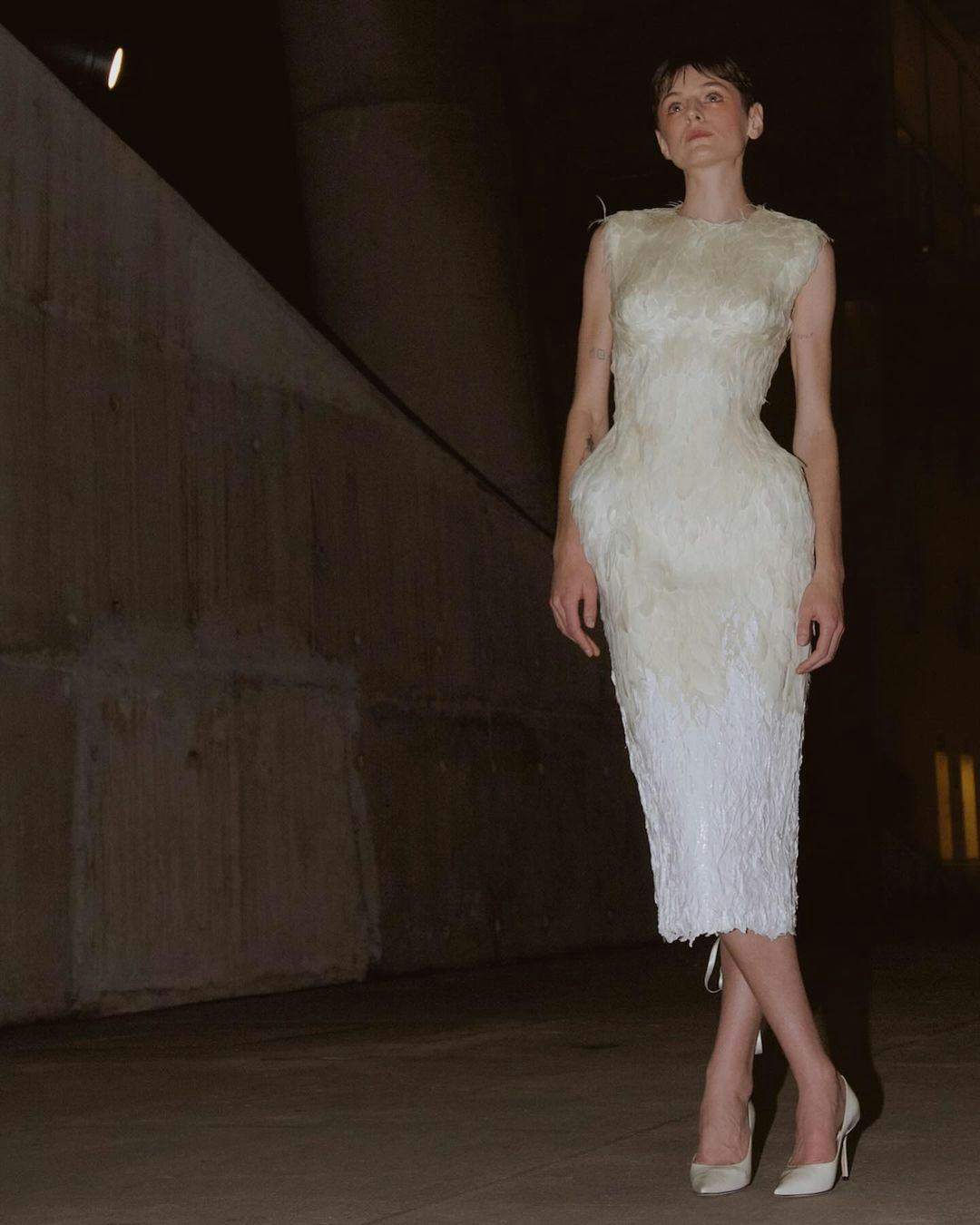 Emma Corrin's Avant-garde Dress Has A Flock Ton Of Feathers