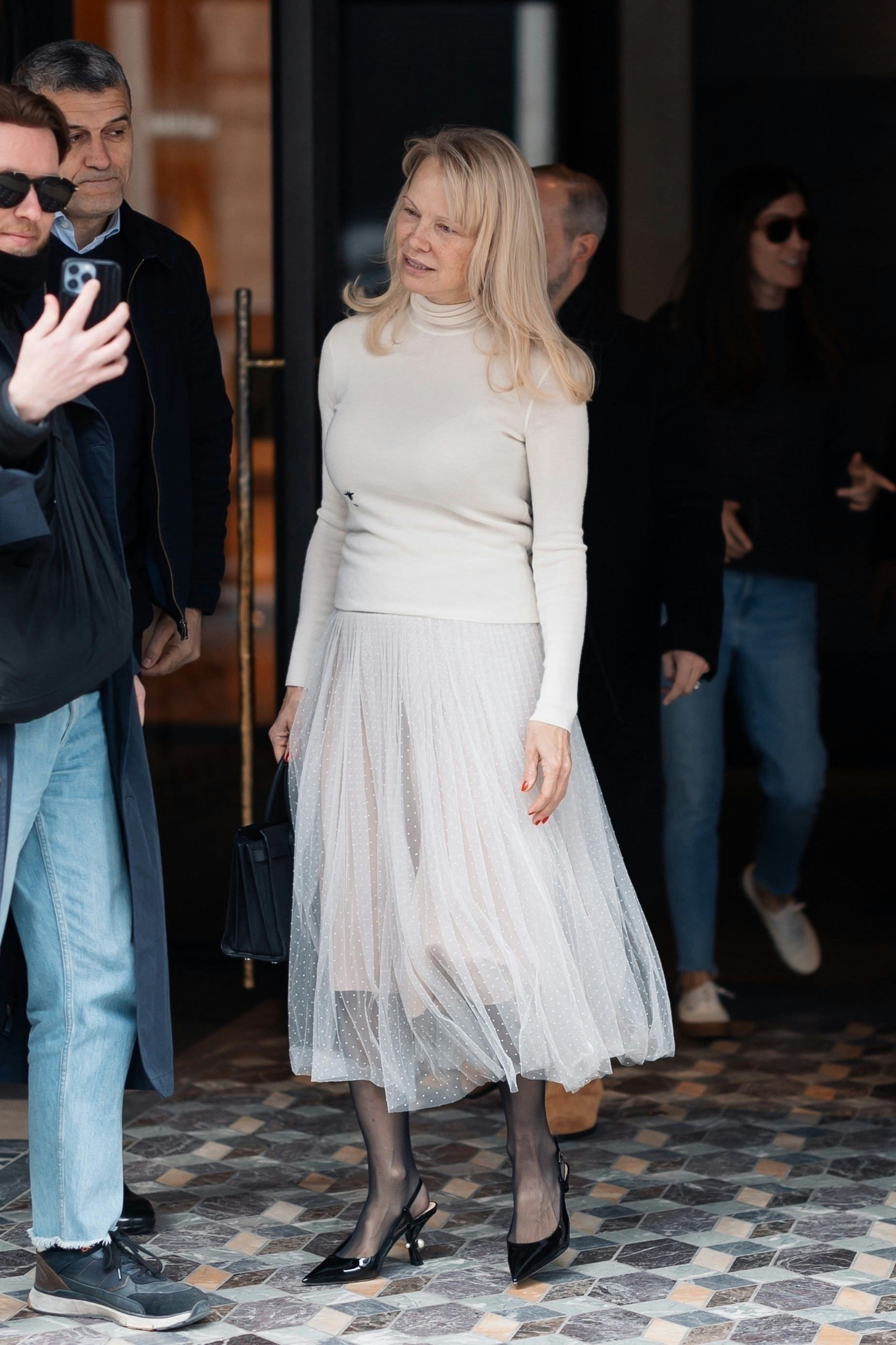 Pamela Anderson’s Pleated Skirt From Dior Was Subtly Sheer