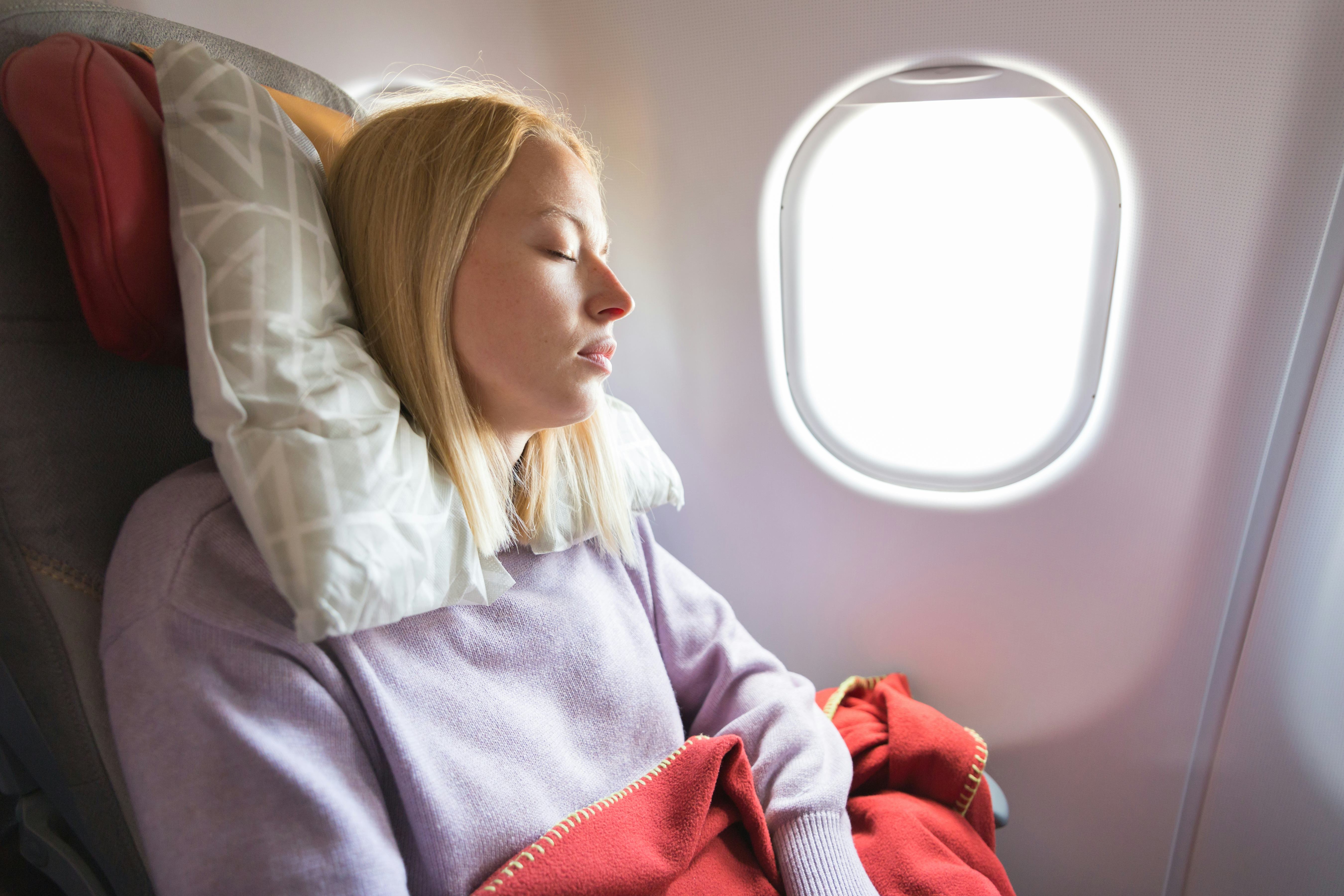How To Fall Asleep On A Flight — And Stay Asleep — According To Experts
