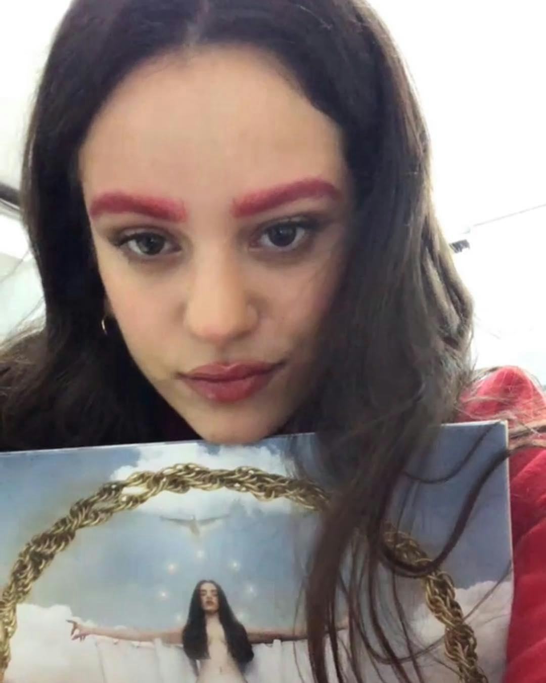 Rosalía’s Most Daring Beauty Looks, From Red Brows to Louis Vuitton Lips