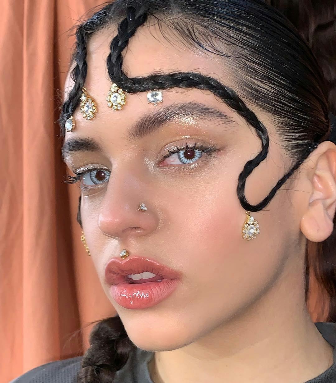 Rosalía’s Most Daring Beauty Looks, From Red Brows to Louis Vuitton Lips